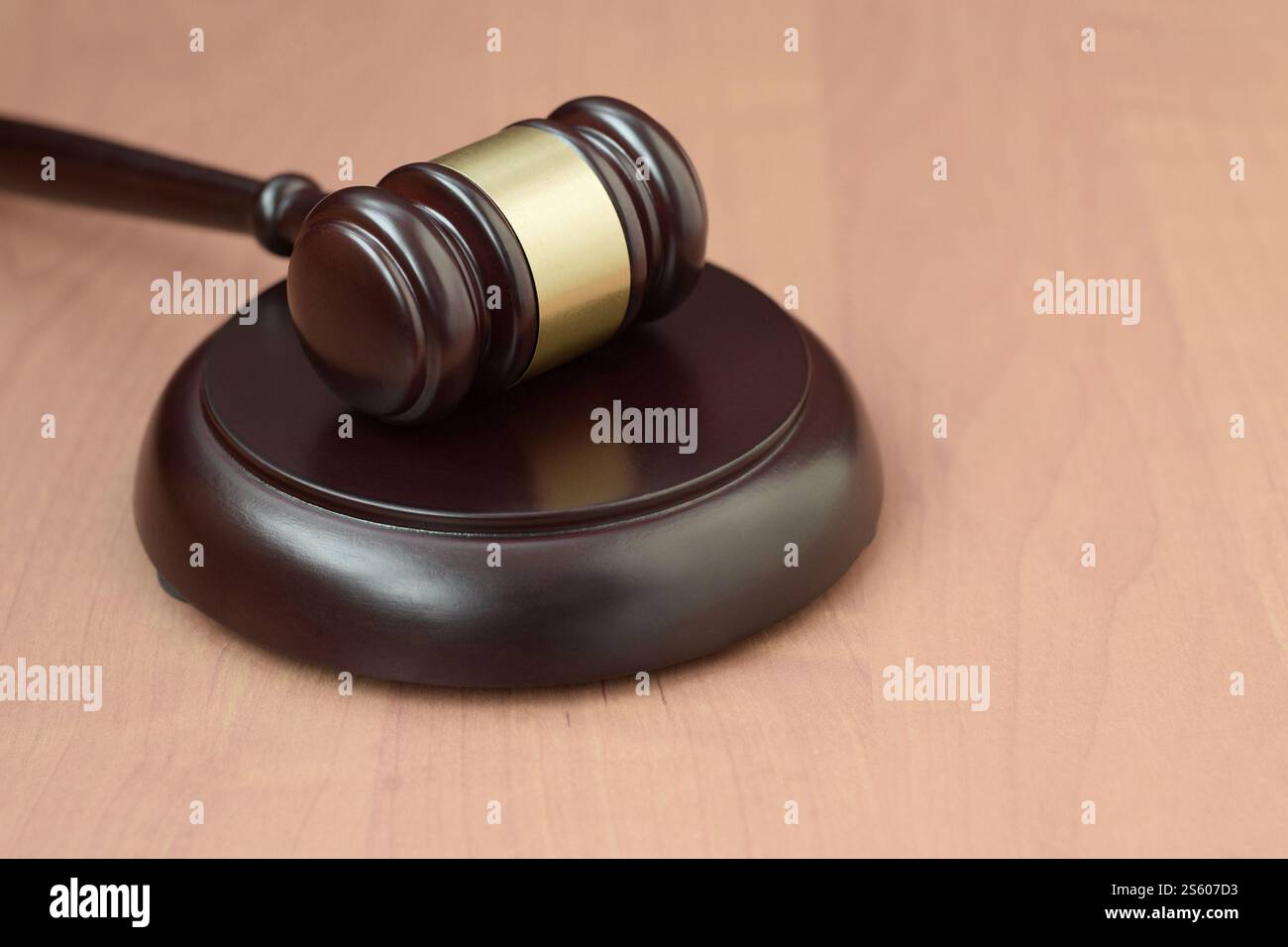 Justice mallet on wooden desk in a courtroom during a judicial trial. Law concept and empty copy ...