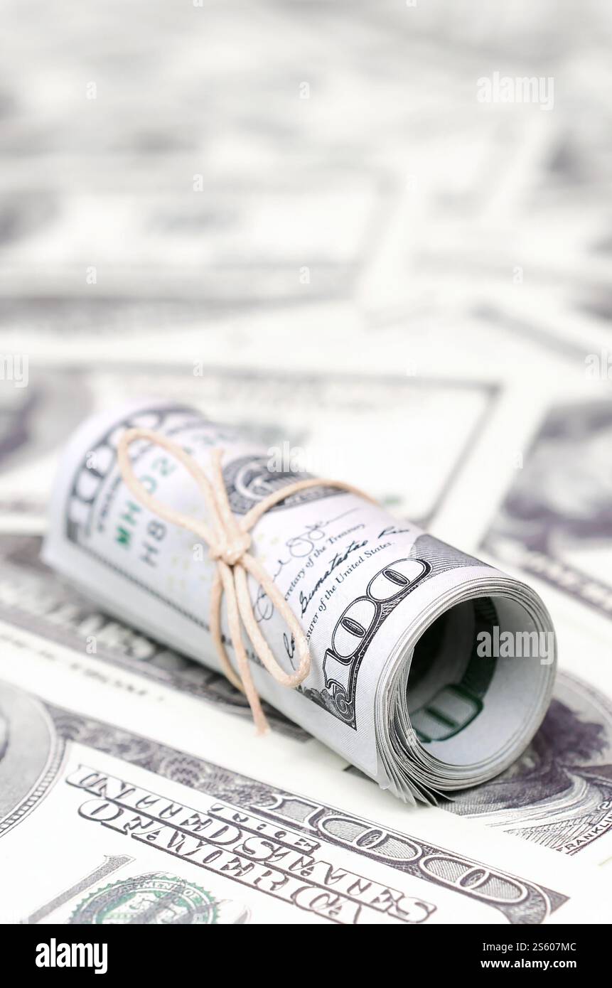 US dollars rolled up and tightened with band lies on a lot of american ...