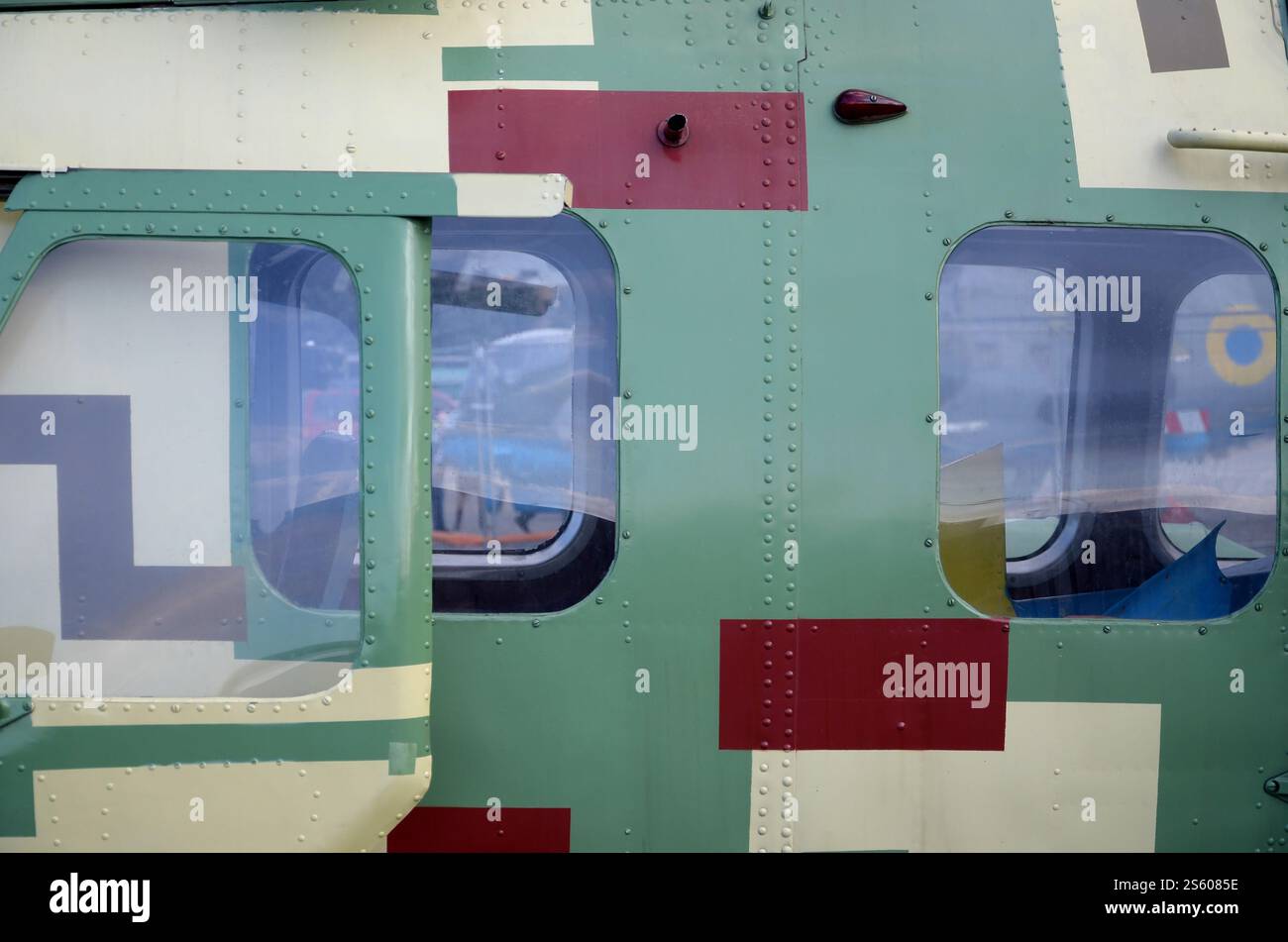 Close up view on helicopter cabin fragment. Camouflage aircraft ...