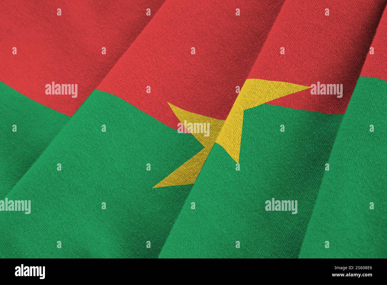 Burkina Faso flag with big folds waving close up under the studio light ...