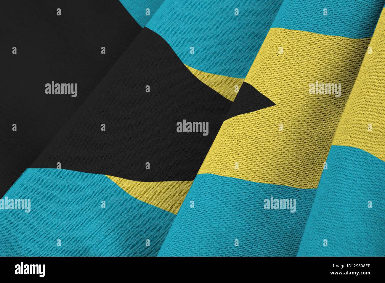 Bahamas flag with big folds waving close up under the studio light ...