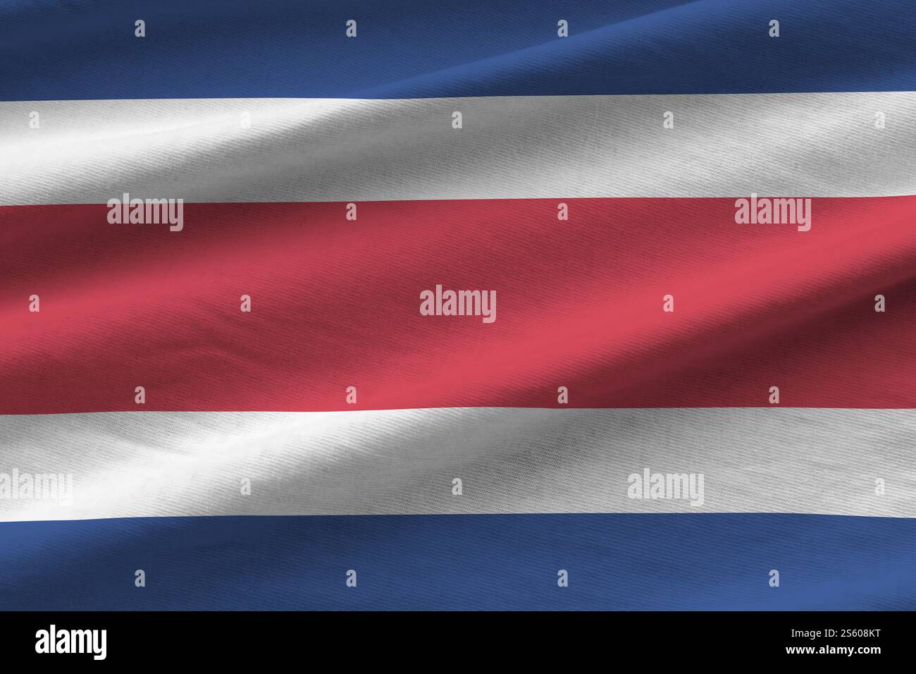 Costa Rica flag with big folds waving close up under the studio light ...