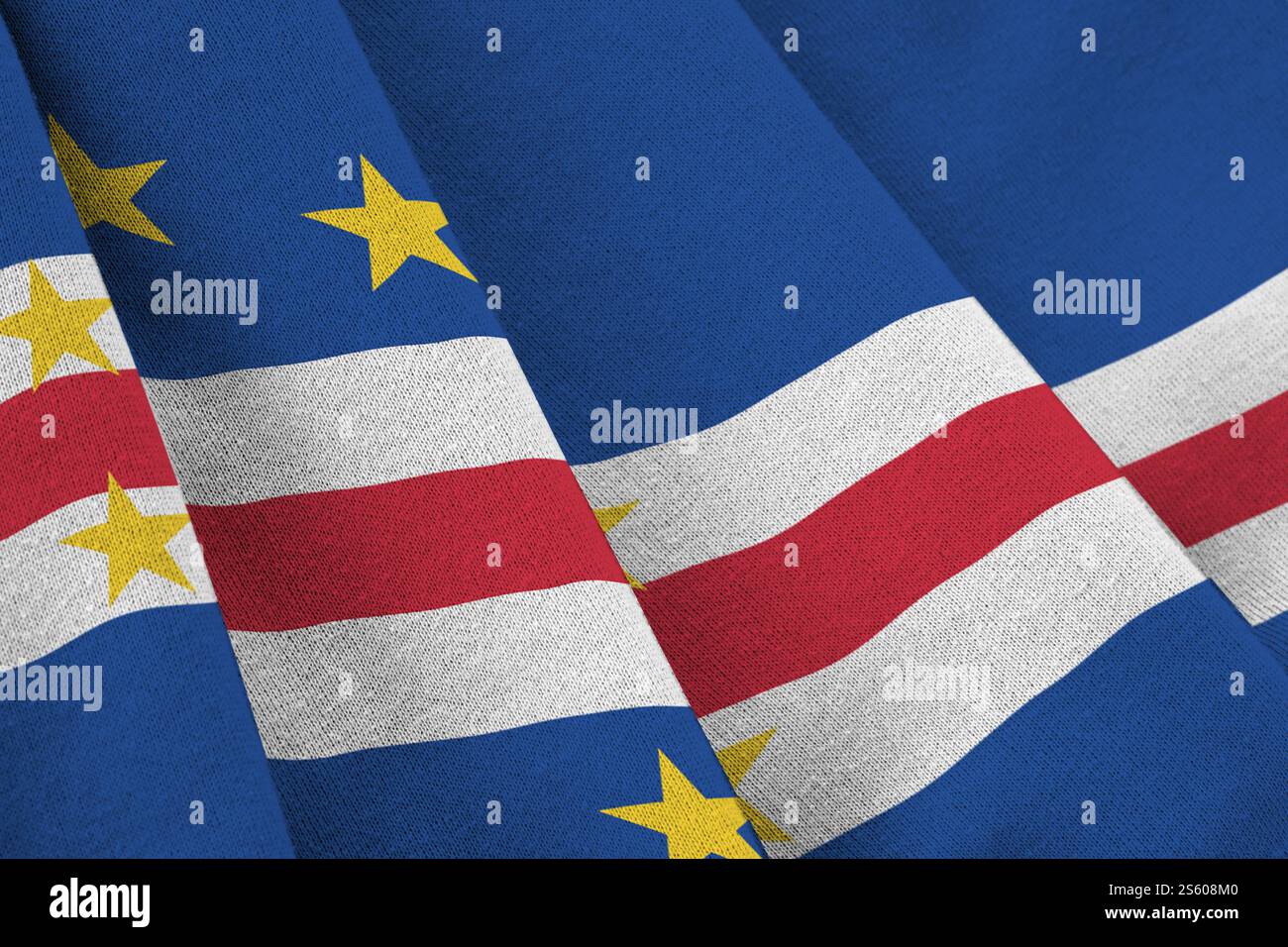 Cabo verde flag with big folds waving close up under the studio light ...