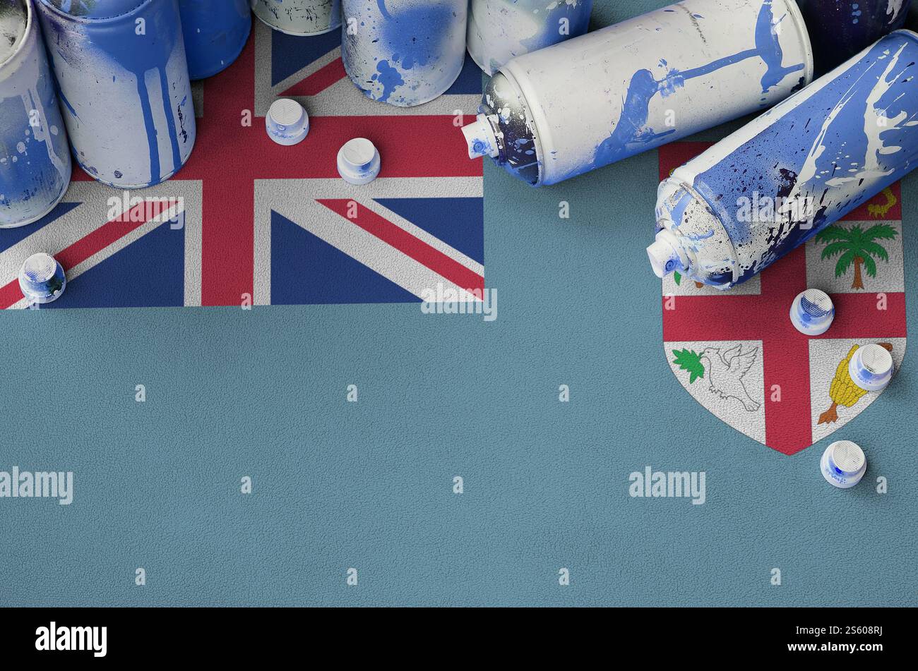 Fiji flag and few used aerosol spray cans for graffiti painting. Street ...