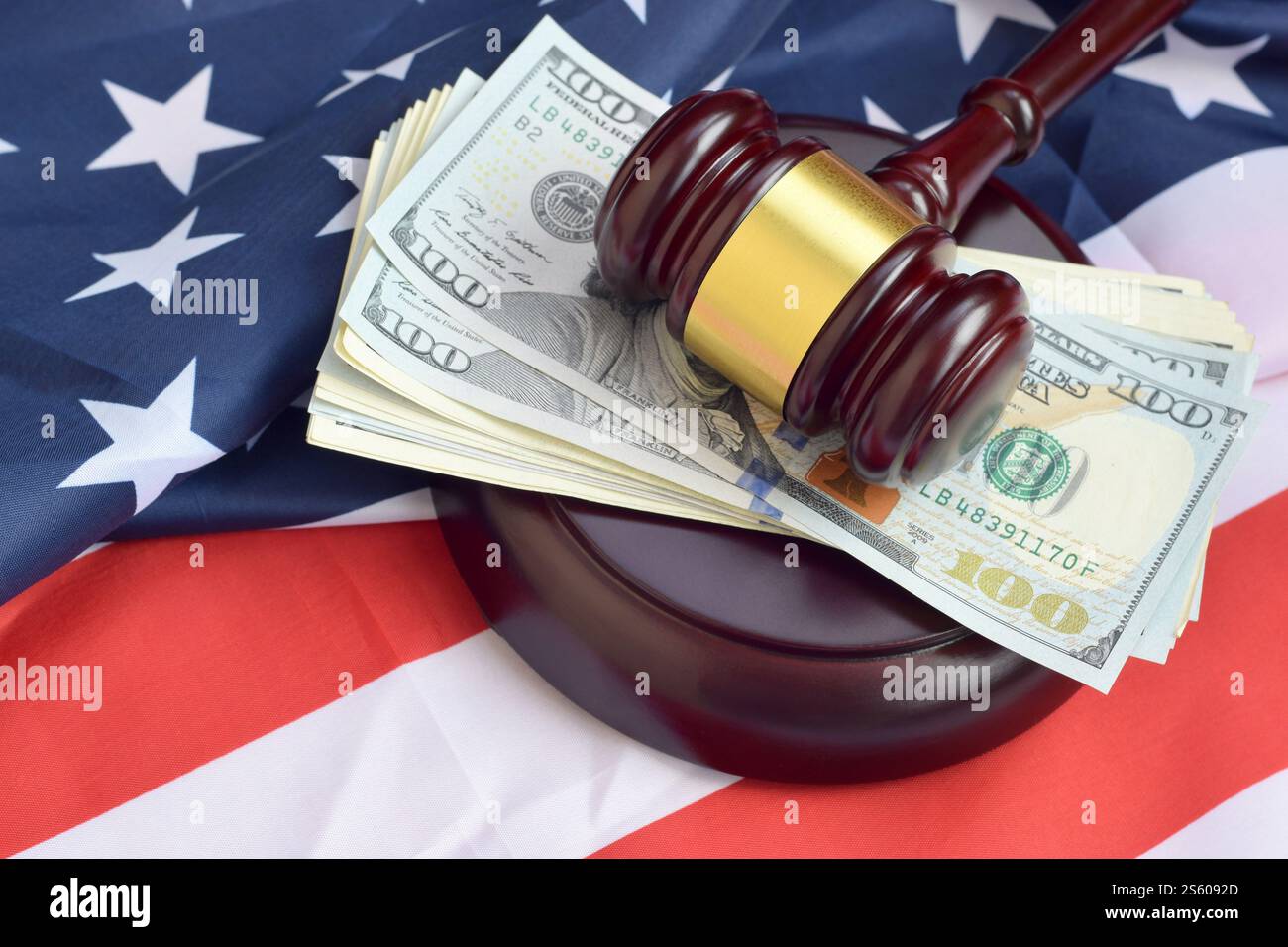 Judge gavel and money on United States of America flag. Many hundred ...