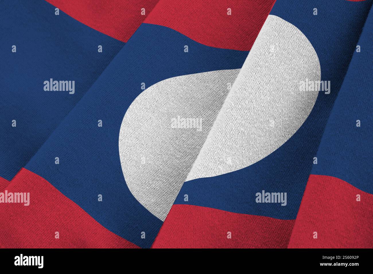 Laos flag with big folds waving close up under the studio light indoors ...