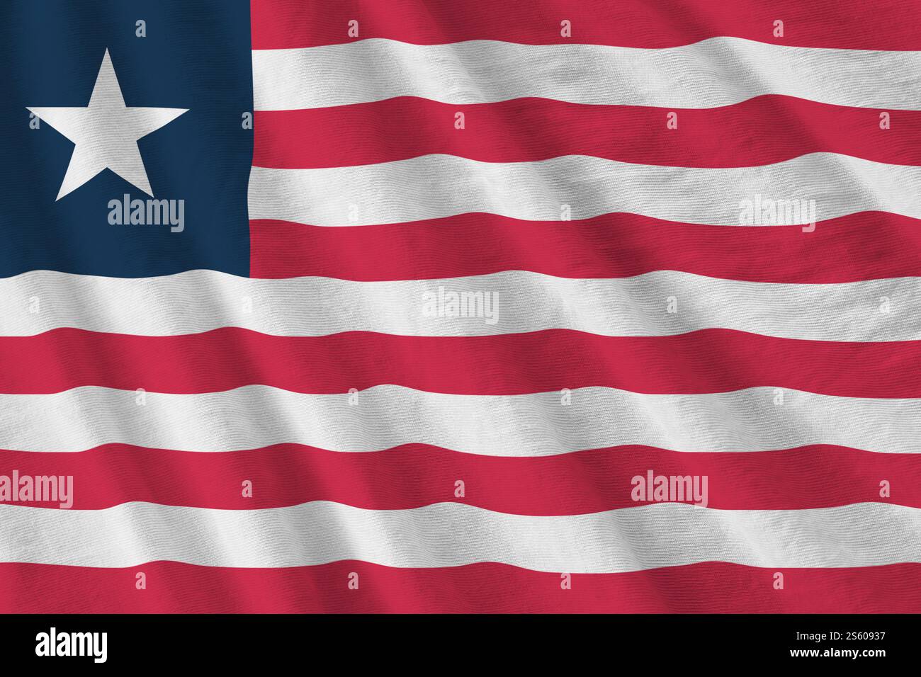 Liberia flag with big folds waving close up under the studio light ...