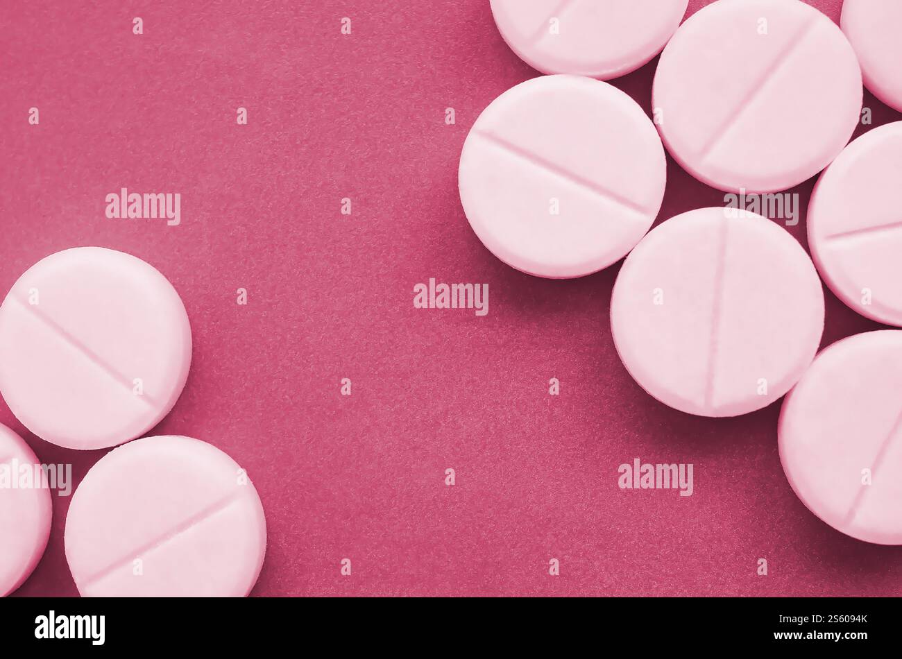 A few white tablets lie on a bright background surface. Background ...