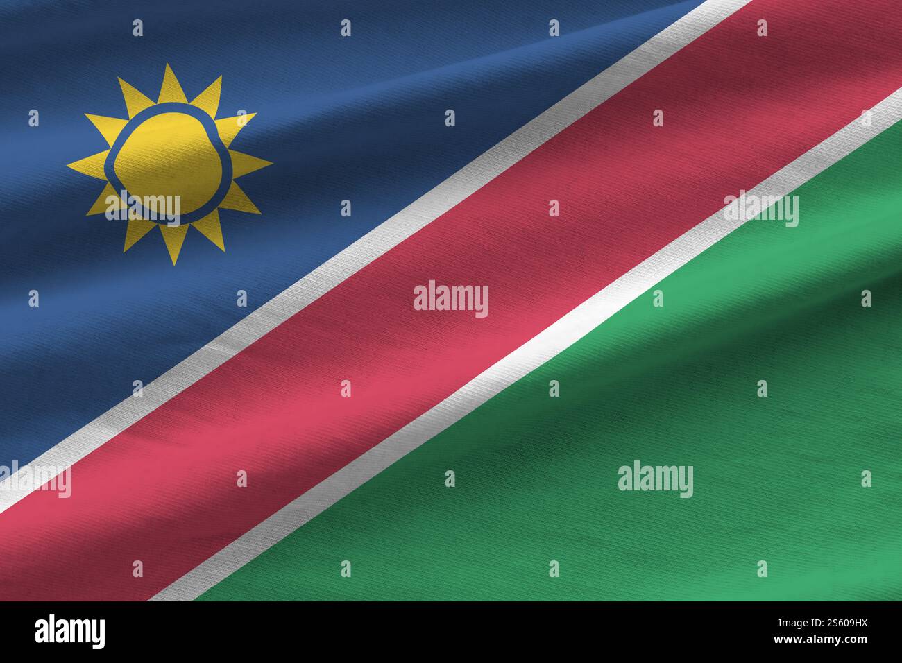 Namibia flag with big folds waving close up under the studio light ...