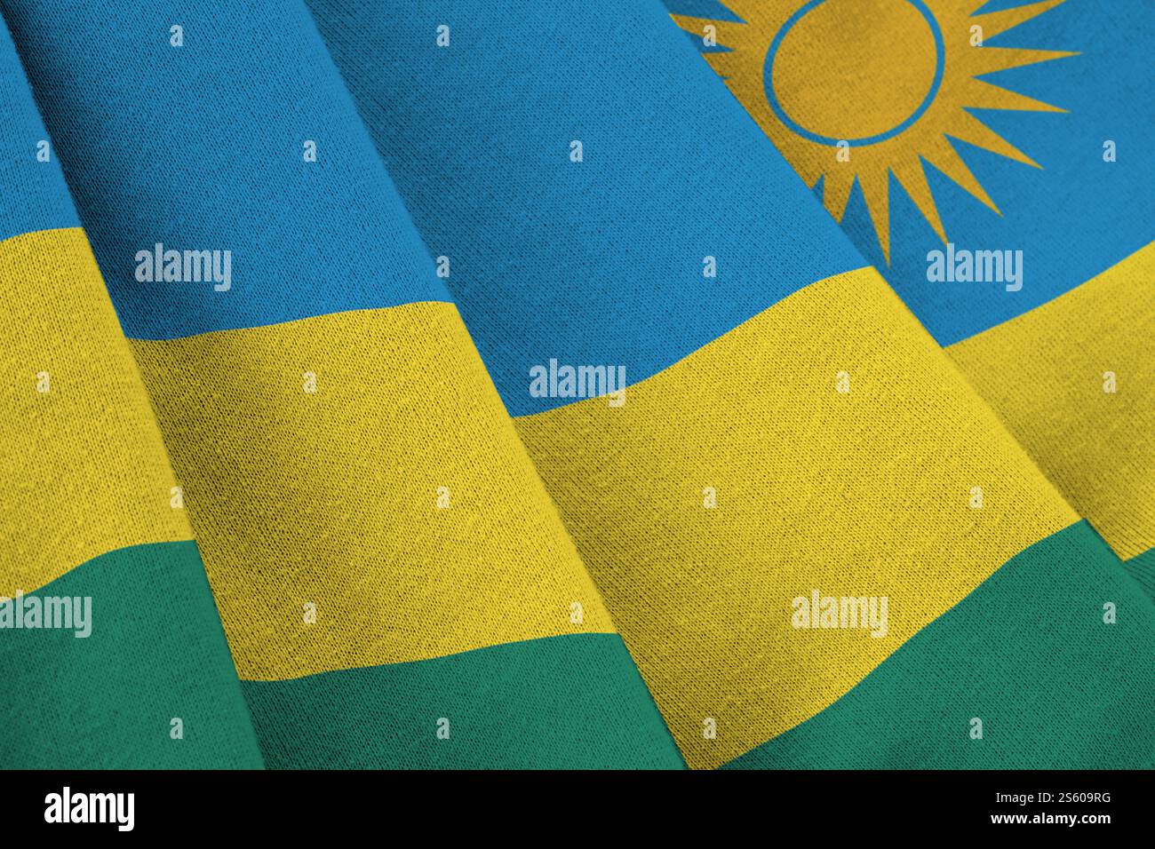 Rwanda flag with big folds waving close up under the studio light ...