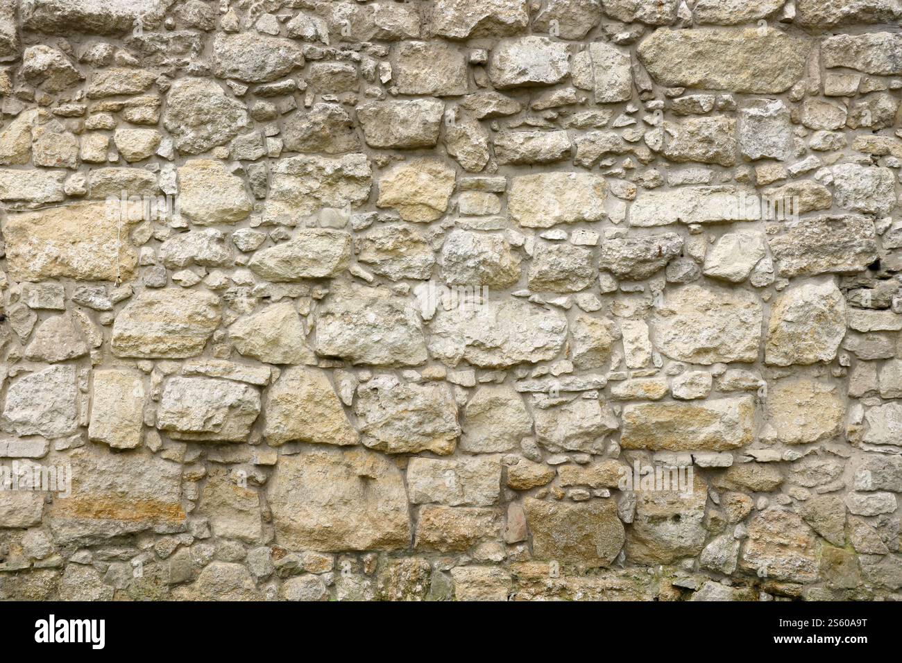 Texture of a stone wall with many big brown and grey stones armed with ...