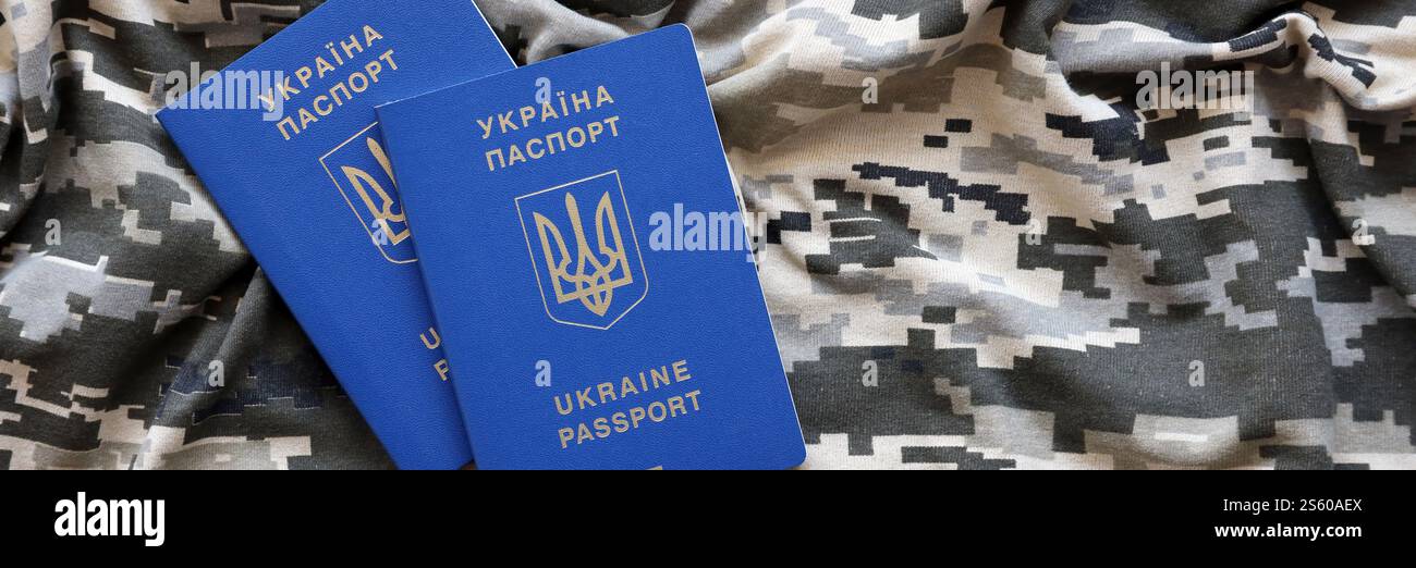 Ukrainian foreign passport on fabric with texture of military pixeled ...