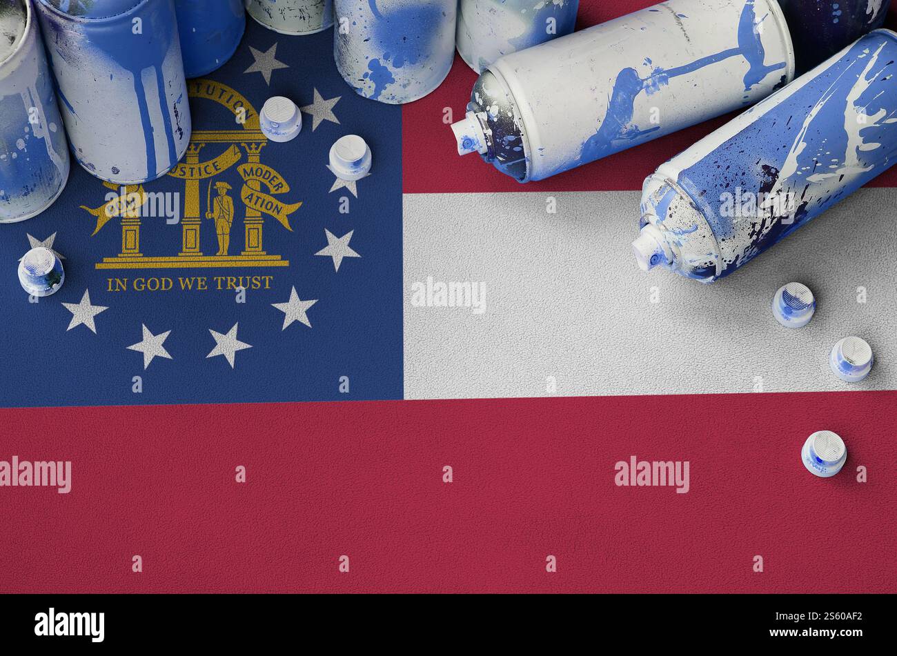 Georgia US state flag and few used aerosol spray cans for graffiti ...