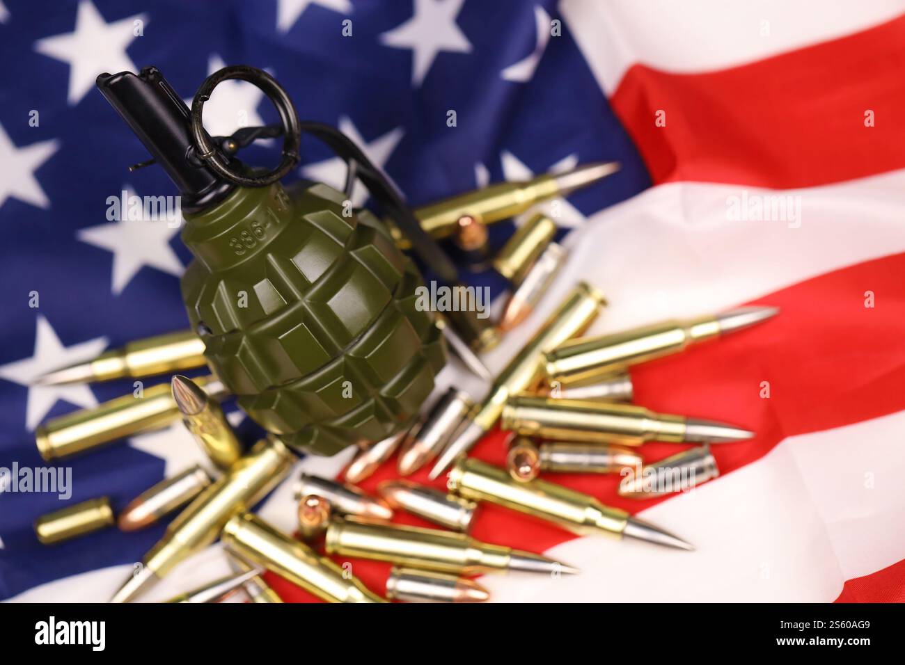 F1 frag grenade and many yellow bullets and cartridges on United States ...