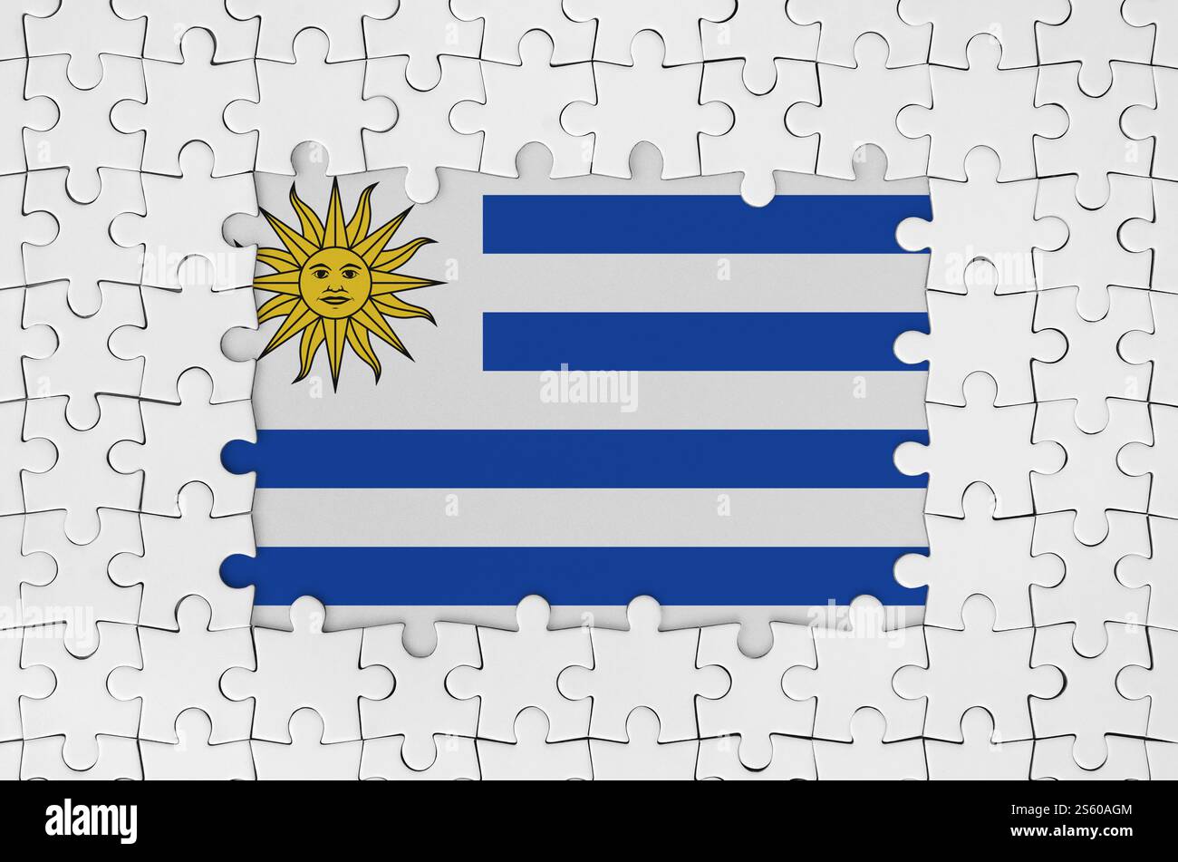 Uruguay flag in frame of white puzzle pieces with missing central parts ...