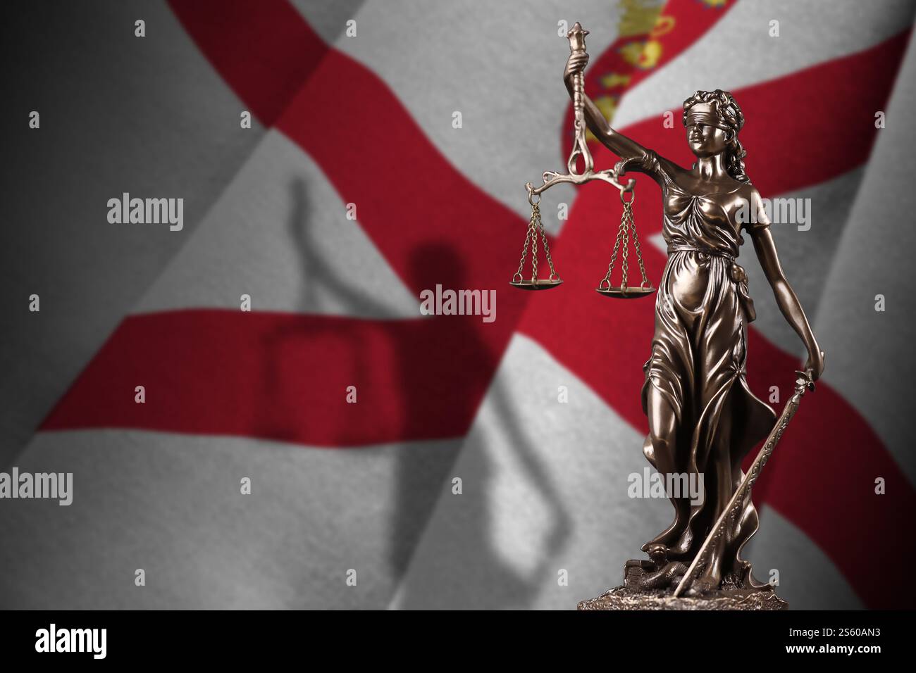Jersey flag with statue of lady justice and judicial scales in dark room. Concept of judgement ...