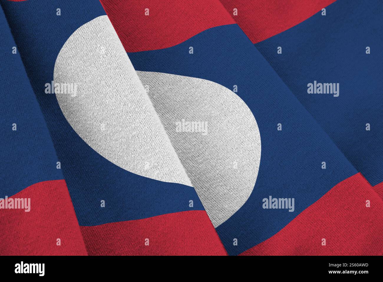 Laos flag with big folds waving close up under the studio light indoors ...