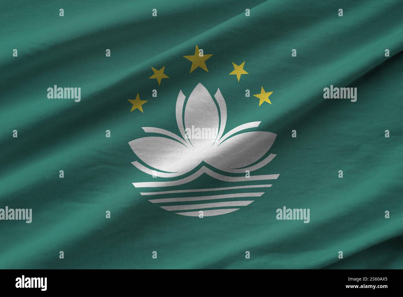 Macau flag with big folds waving close up under the studio light ...