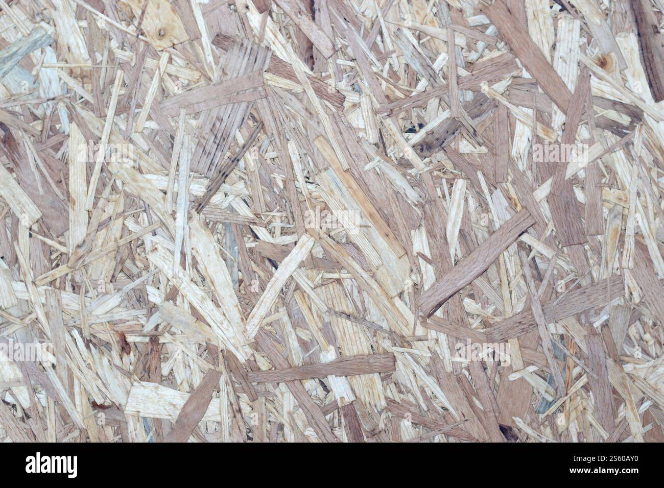 OSB boards made of brown wood chips sanded into a wooden background ...