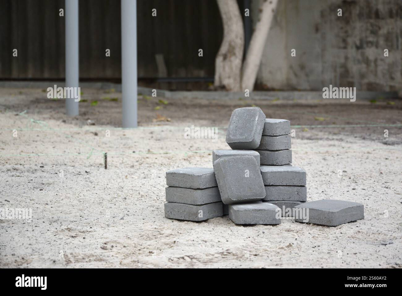 Small pile of gray walkway slabs lying in stack outdoors. Material for ...