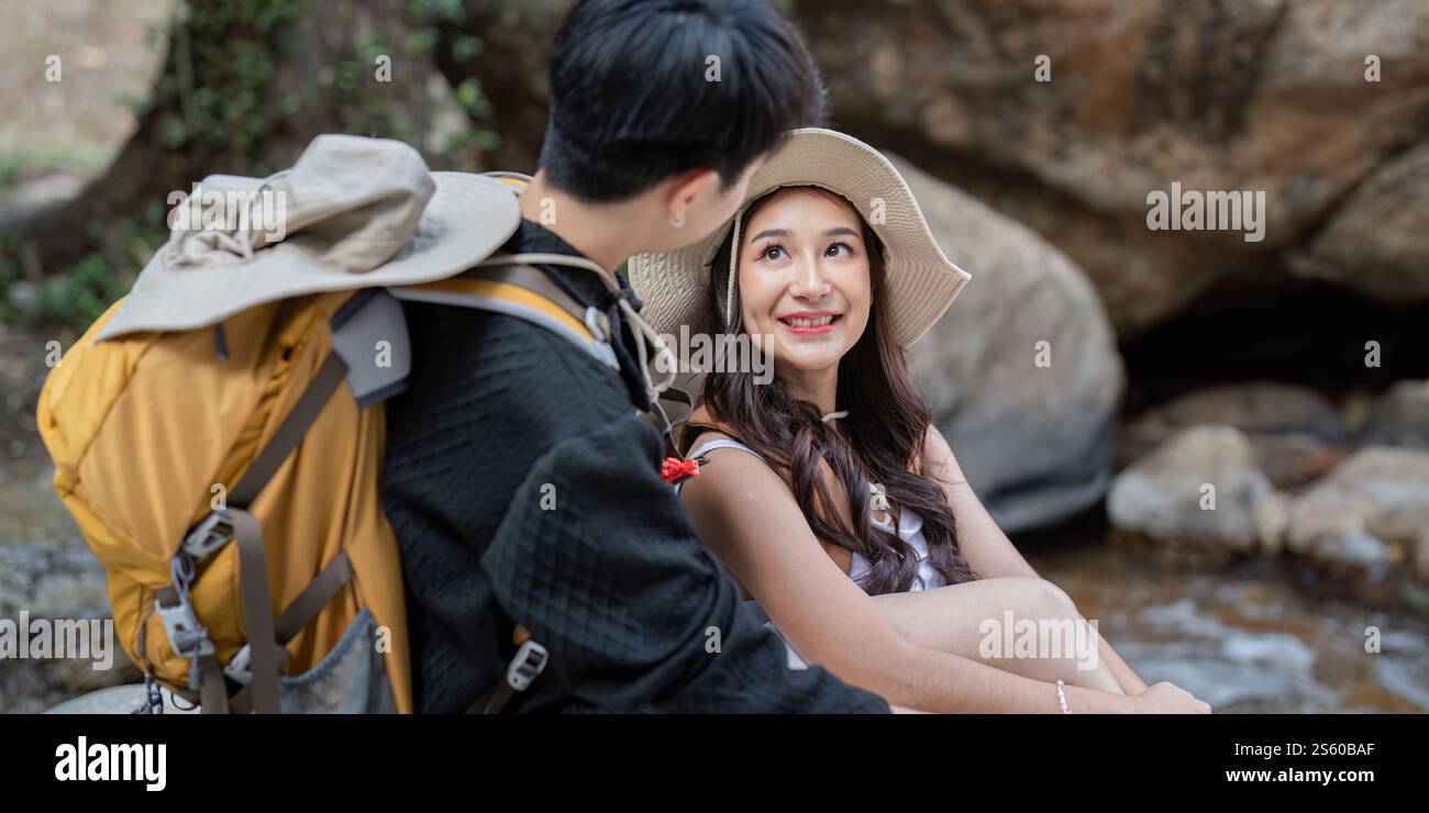 LGBT couple enjoying a playful conversation by a serene stream during ...