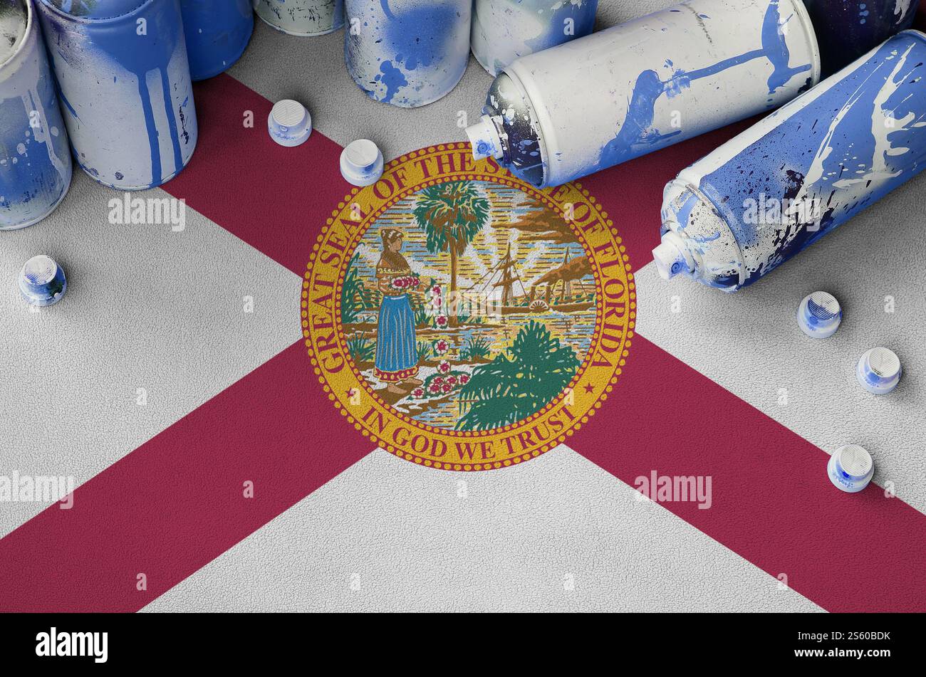 Florida US state flag and few used aerosol spray cans for graffiti ...