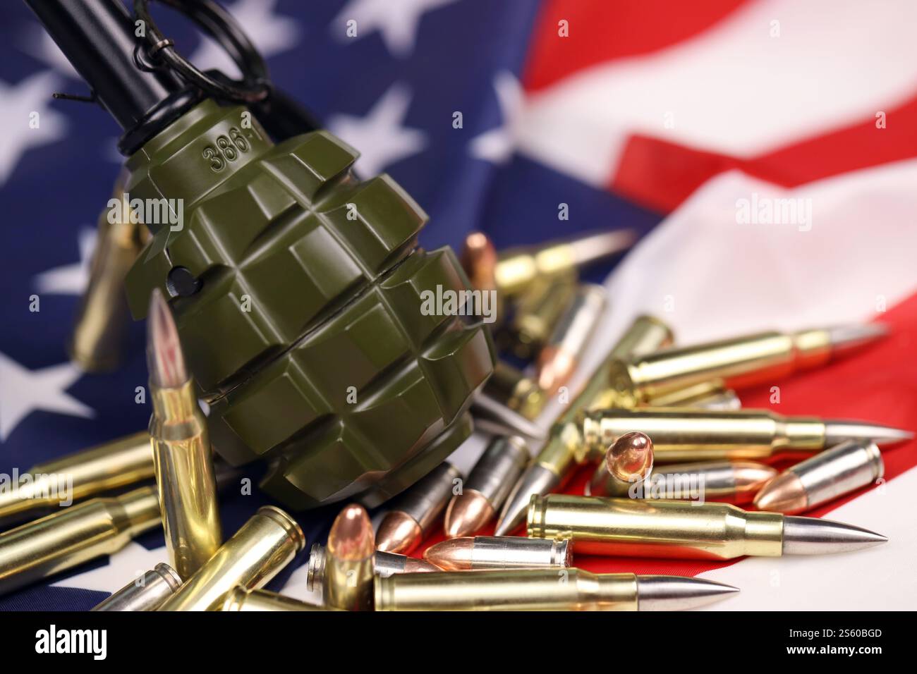 F1 frag grenade and many yellow bullets and cartridges on United States ...