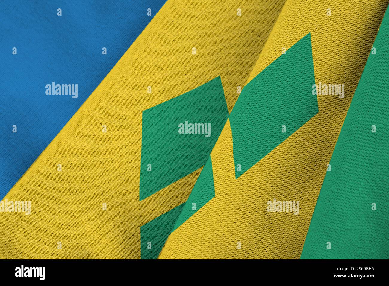 Saint Vincent and the Grenadines flag with big folds waving close up ...