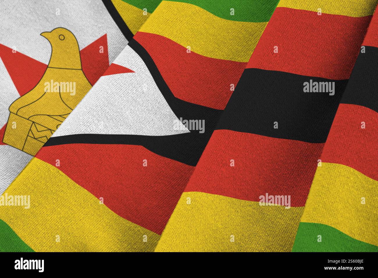 Zimbabwe flag with big folds waving close up under the studio light ...