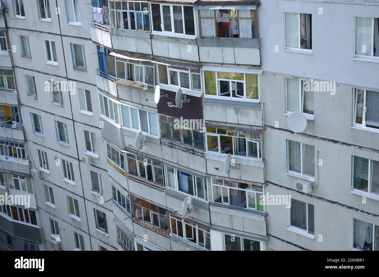 Facade of a grey multi storey soviet panel building. Russian old urban ...