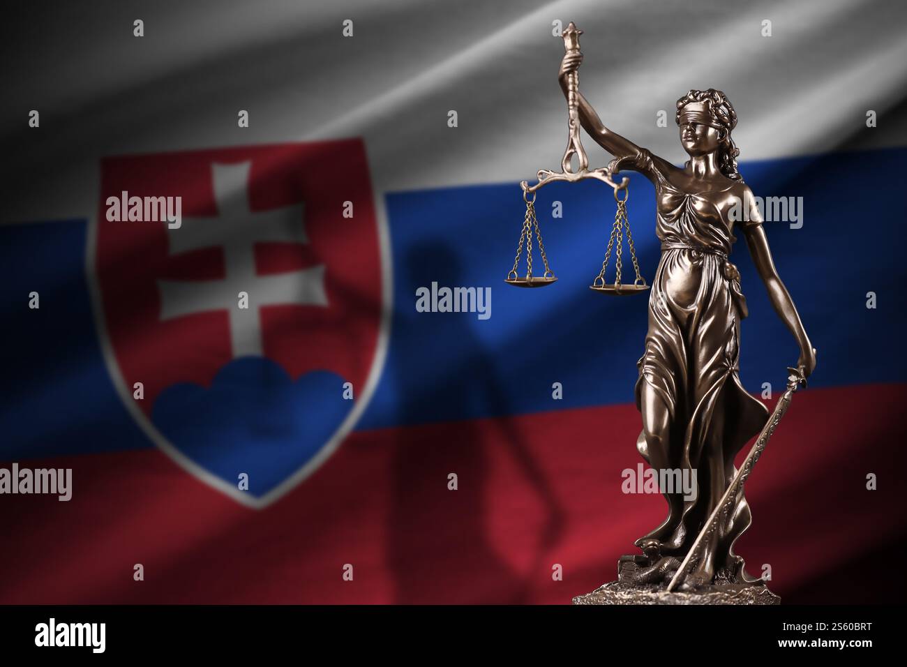 Slovakia flag with statue of lady justice and judicial scales in dark ...
