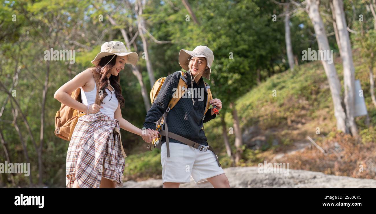 LGBT couple hiking hand in hand through a beautiful natural landscape ...