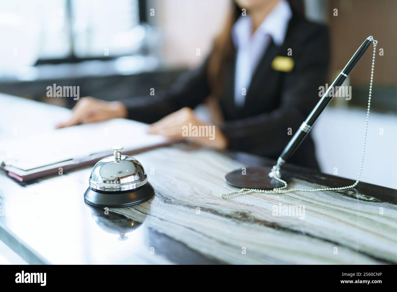 Hotel receptionist in uniforms at desk in lobby Friendly and welcome ...