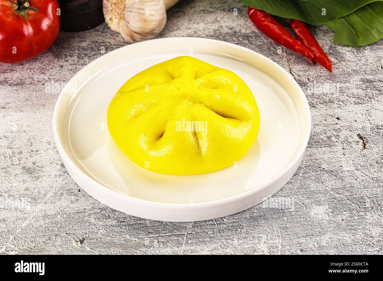 Asian stuffed steamed yellow Bun Bao Stock Photo - Alamy