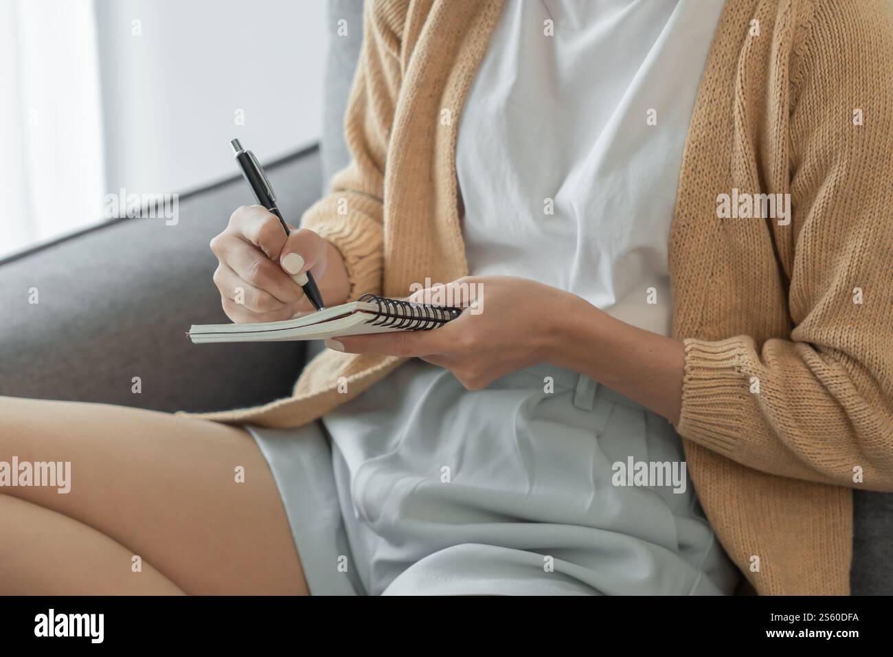 Asian Business woman working from office taking reading and writing ...