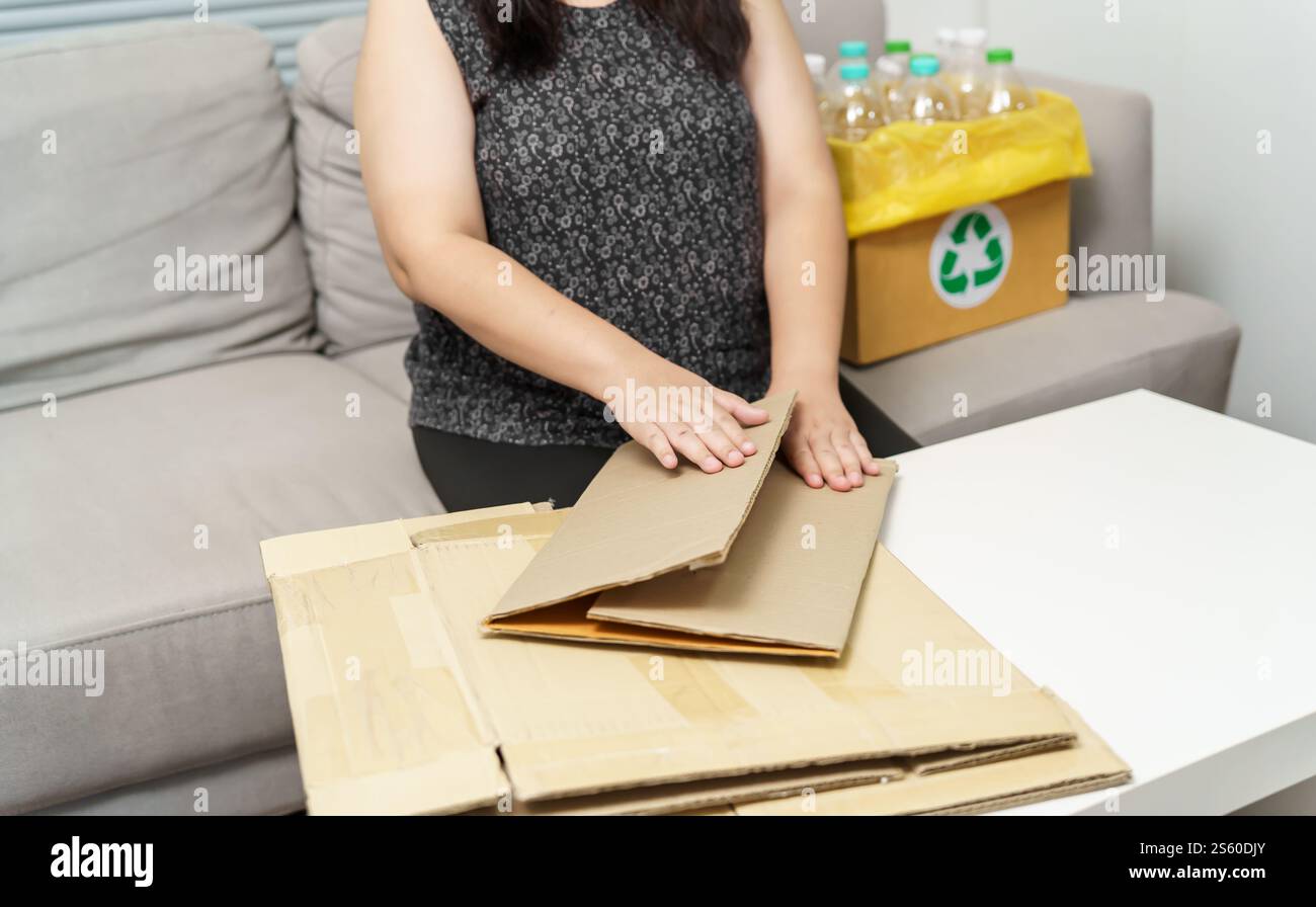 Home recycle eco zero waste concept Woman using recycle paper box. Stacking brown cardboard box ...