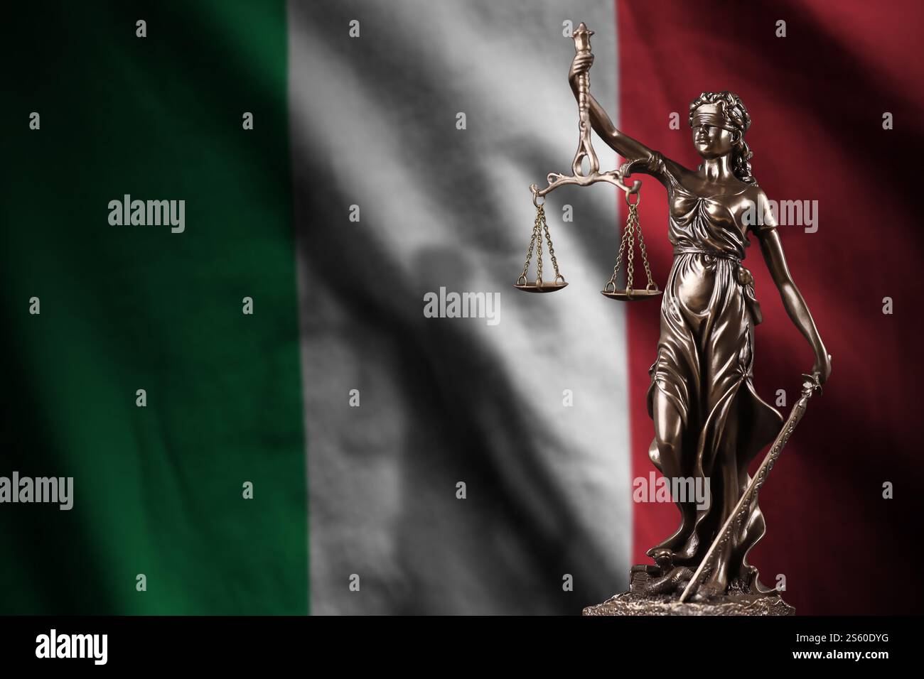 Italy flag with statue of lady justice and judicial scales in dark room ...