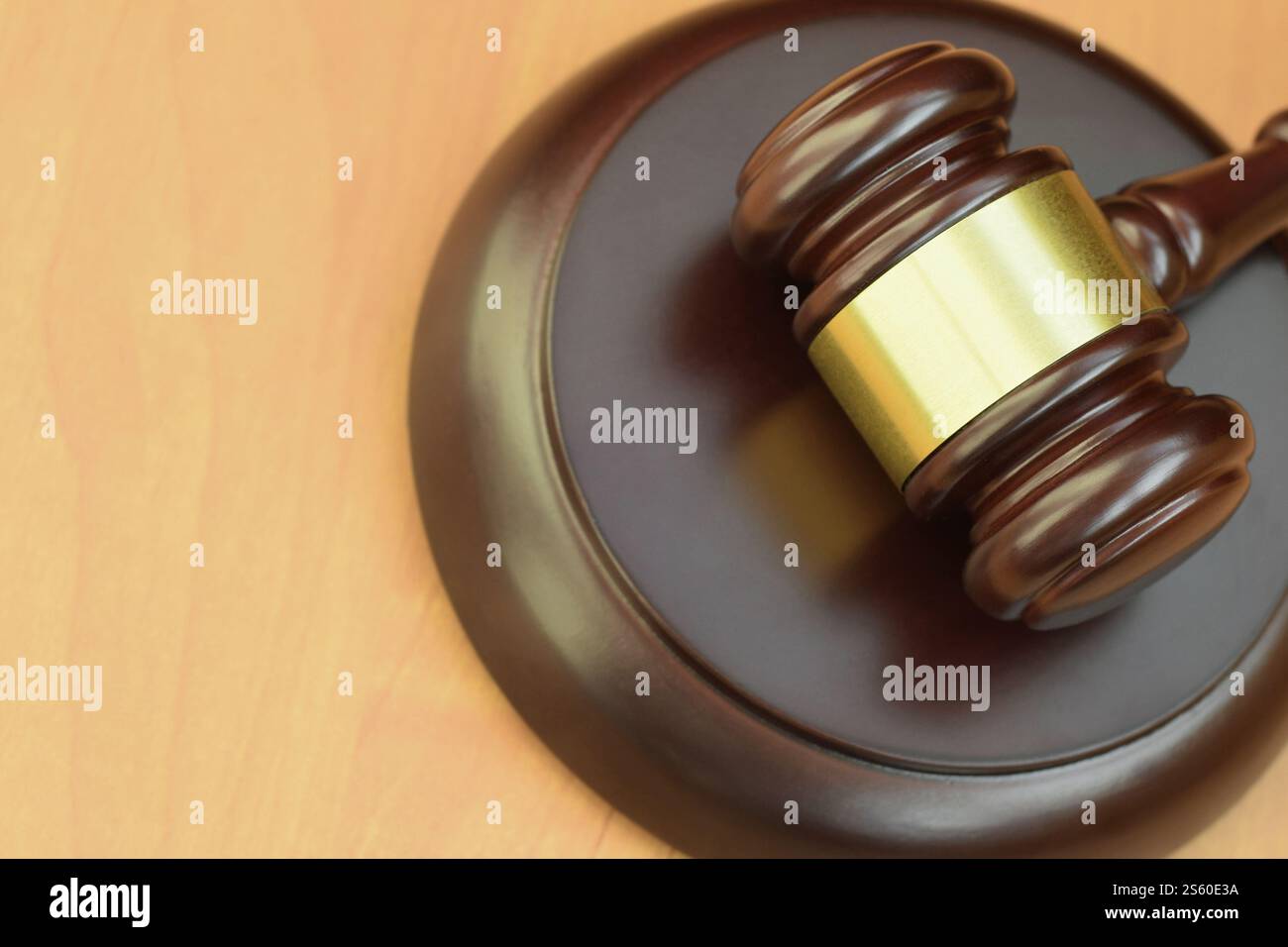 Justice mallet on wooden desk in a courtroom during a judicial trial. Law concept and empty copy ...