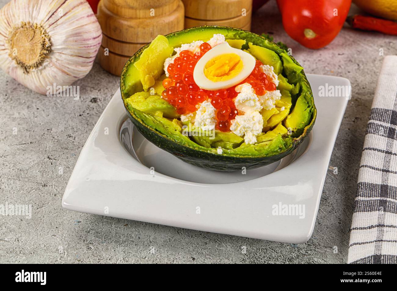 Avocado with red caviar and quil egg and soft cheese Stock Photo - Alamy