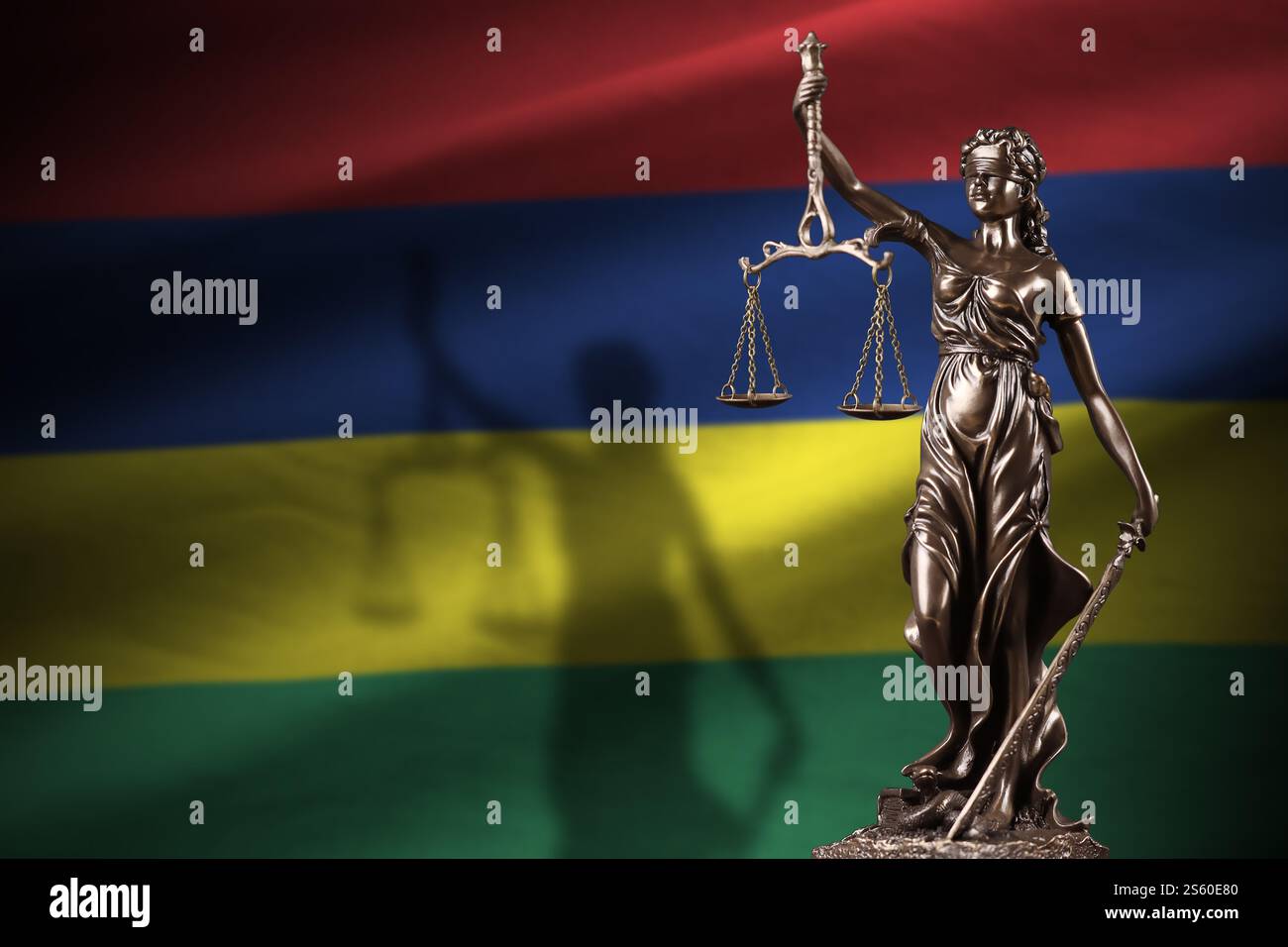 Mauritius flag with statue of lady justice and judicial scales in dark ...