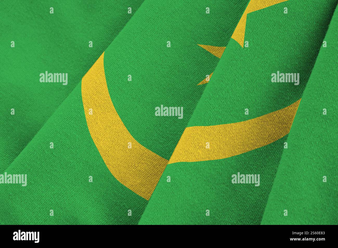 Mauritania flag with big folds waving close up under the studio light ...