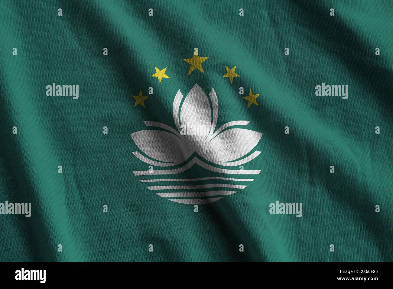 Macau flag with big folds waving close up under the studio light ...