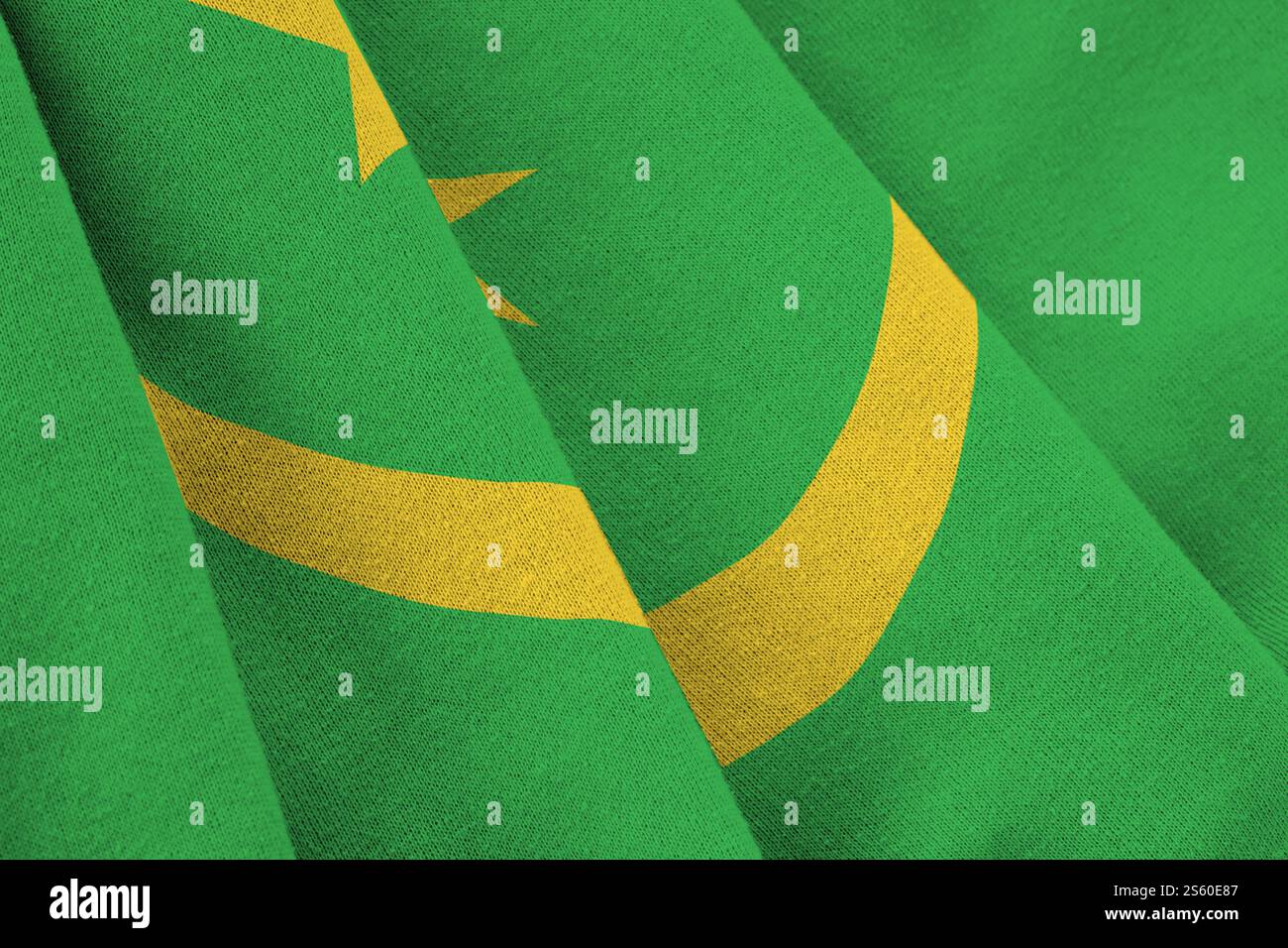 Mauritania flag with big folds waving close up under the studio light ...