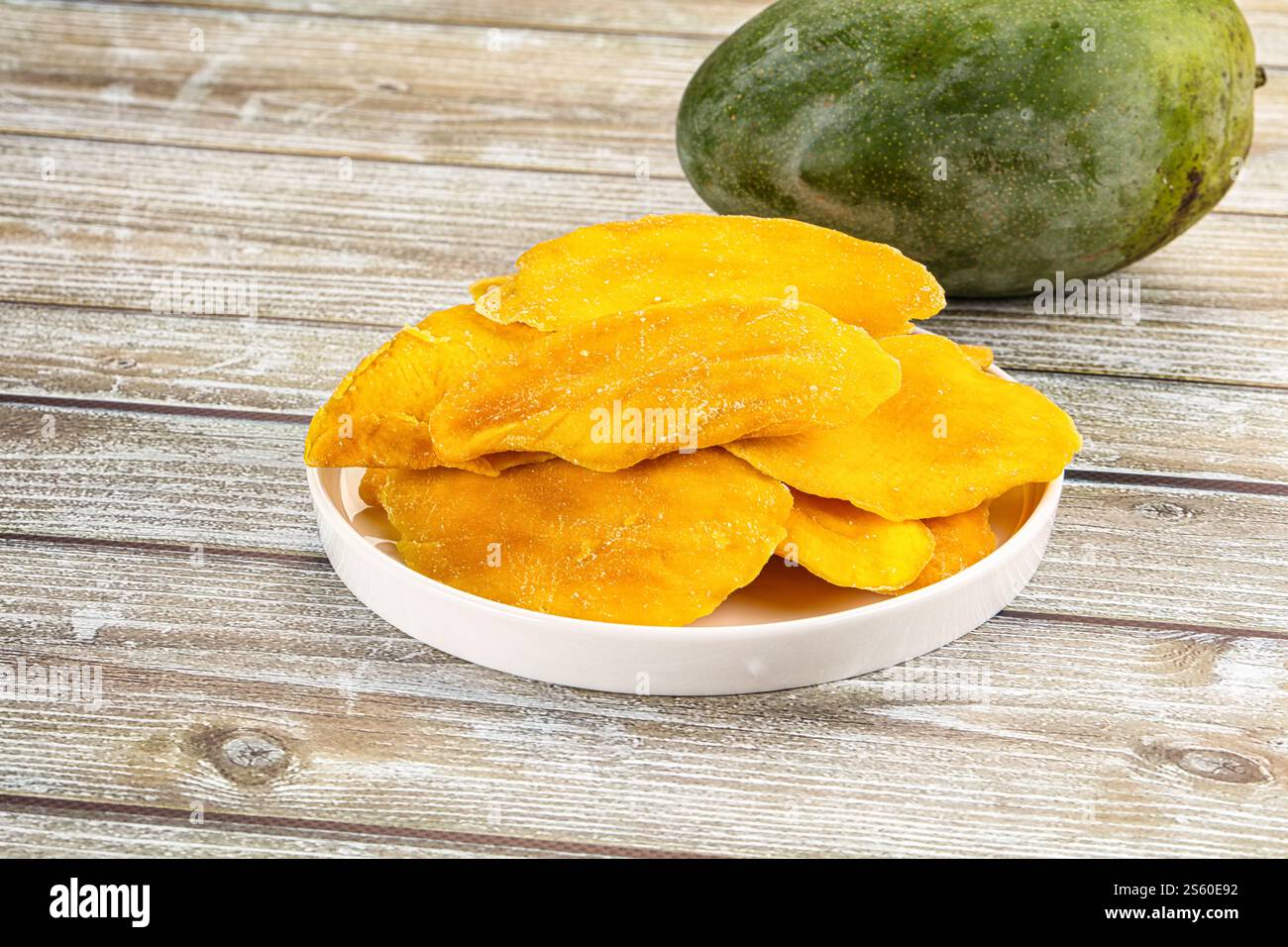 Dry sweet yellow mango snack in the plate Stock Photo - Alamy