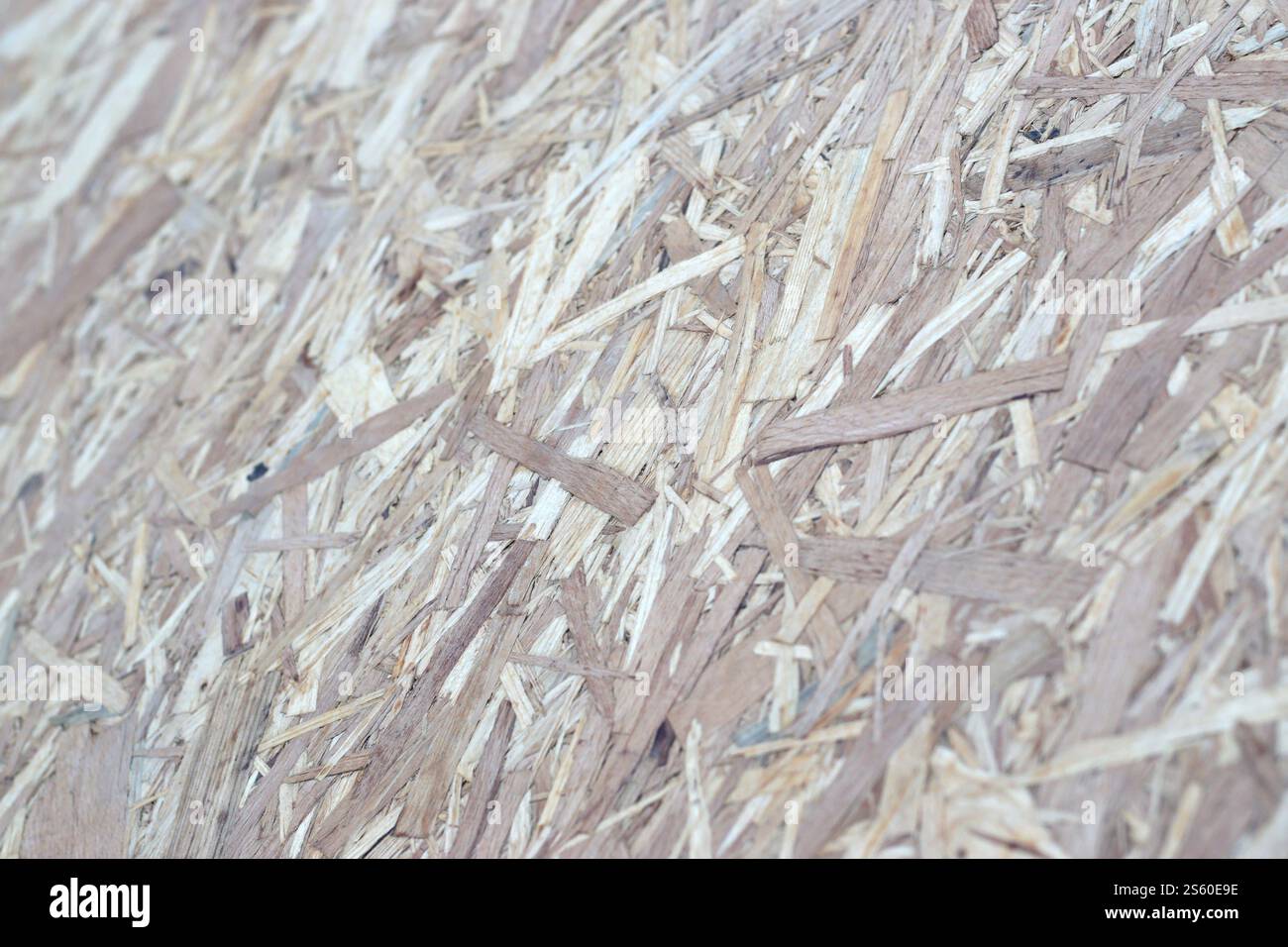 OSB boards made of brown wood chips sanded into a wooden background ...