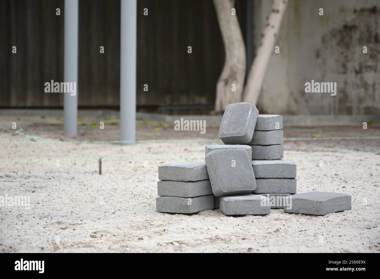 Small pile of gray walkway slabs lying in stack outdoors. Material for ...