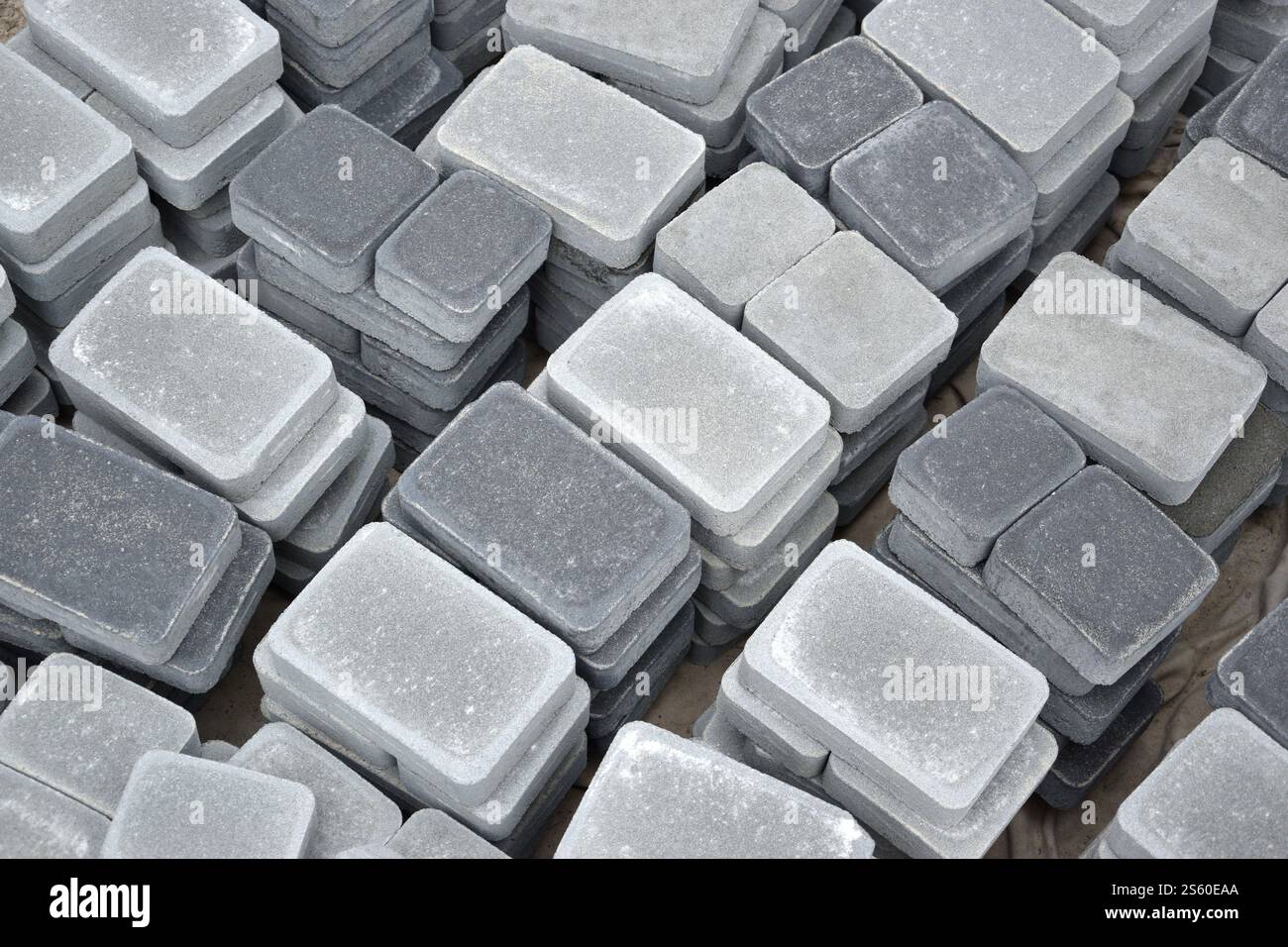 Pile of gray and dark grey walkway slab lying down outdoor. Material ...