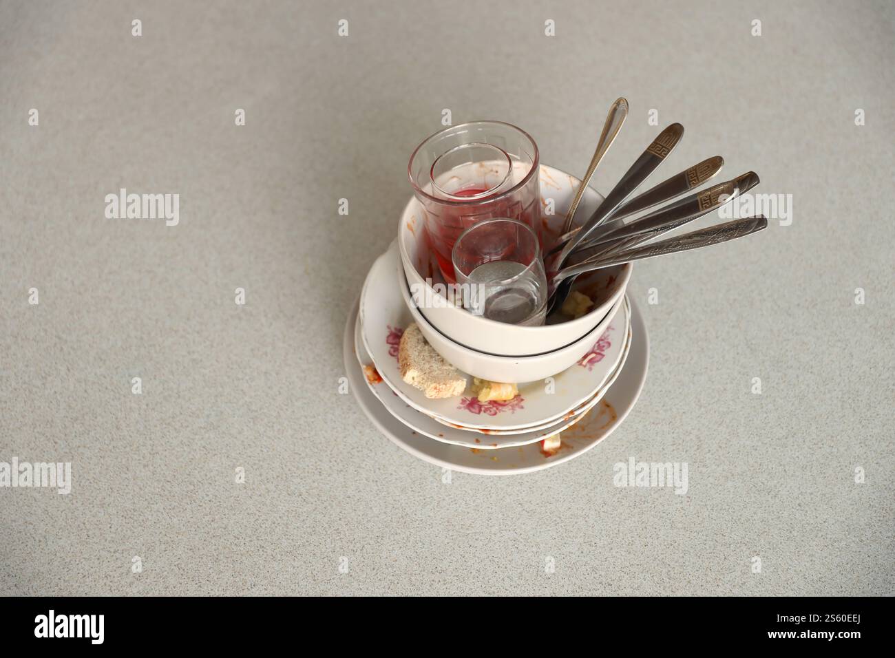 Stack of dirty dishes with food leftovers on the table after meal ...