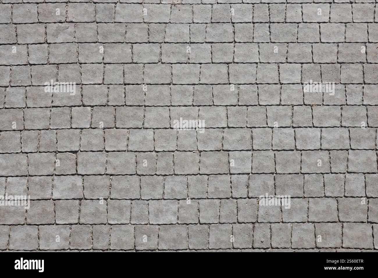 Gray color paving slabs in the pedestrian street sidewalk. Rough ...