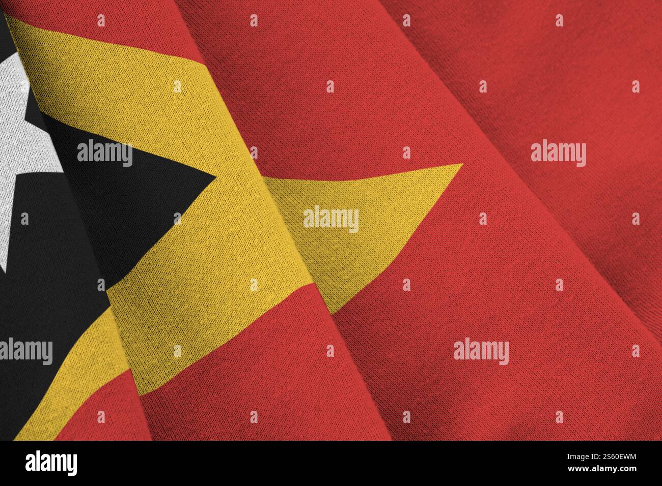 Timor Leste flag with big folds waving close up under the studio light ...